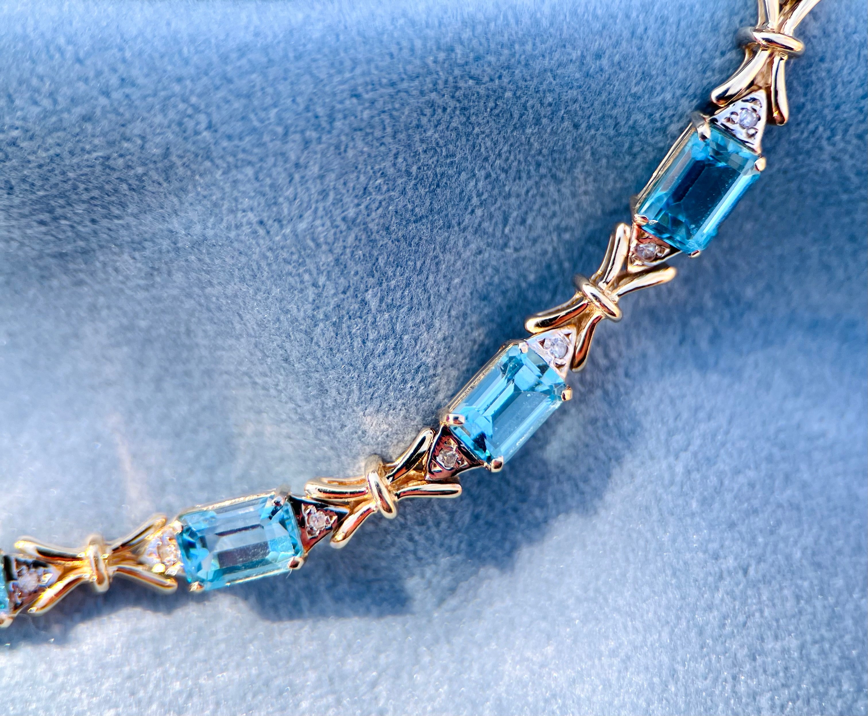 “Frost and Bows” Emerald Cut Blue Topaz with Diamond Accents in 14k Ye ...